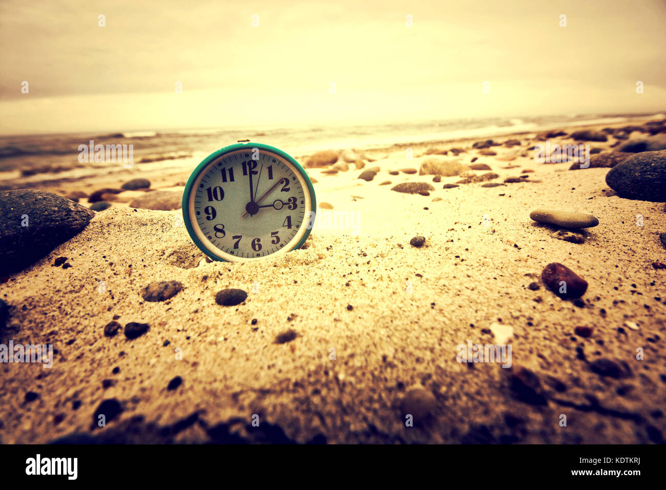 Clock on the beach. Time and business concept. Vintage retro picture ...