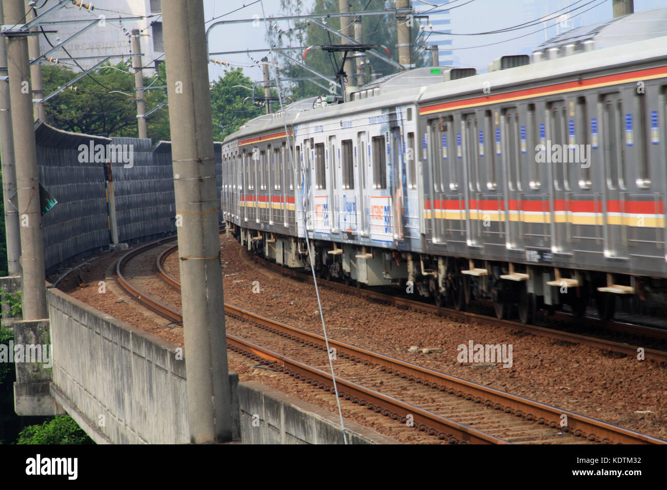 JAKARTA, INDONESIA - JULY 14, 2017: Commuter Line (train) arrive at Juanda railway station ...