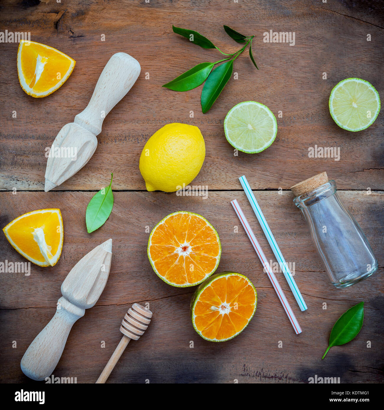 Mixed fresh citrus fruits and orange leaves background. Ingredients for ...