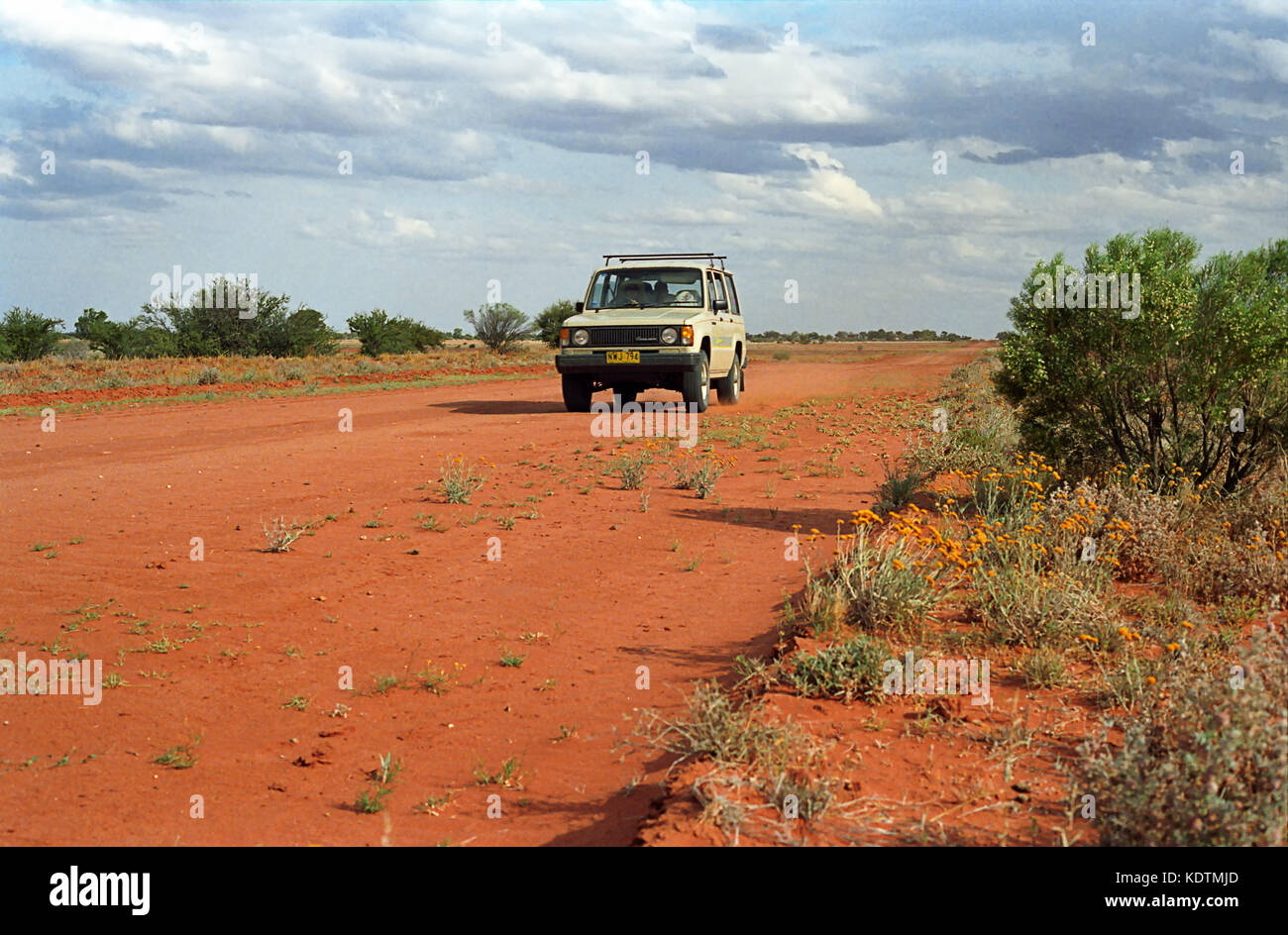 A 4WD on a red dirt outback track, the Cut Line, between Wanaaring and ...