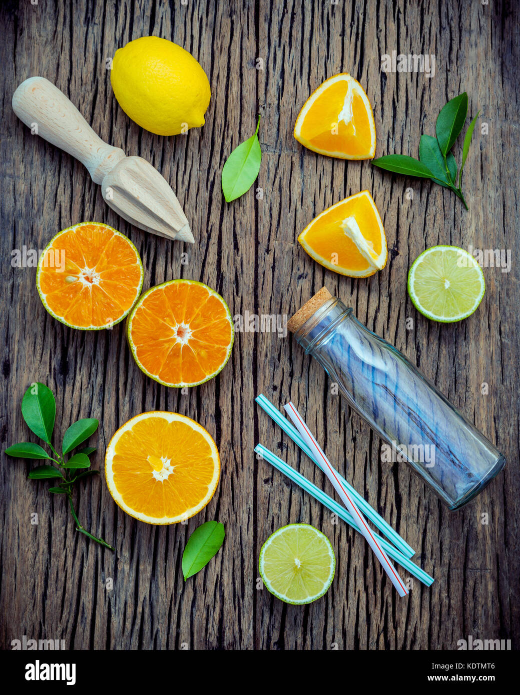 Mixed fresh citrus fruits and orange leaves background. Ingredients for ...