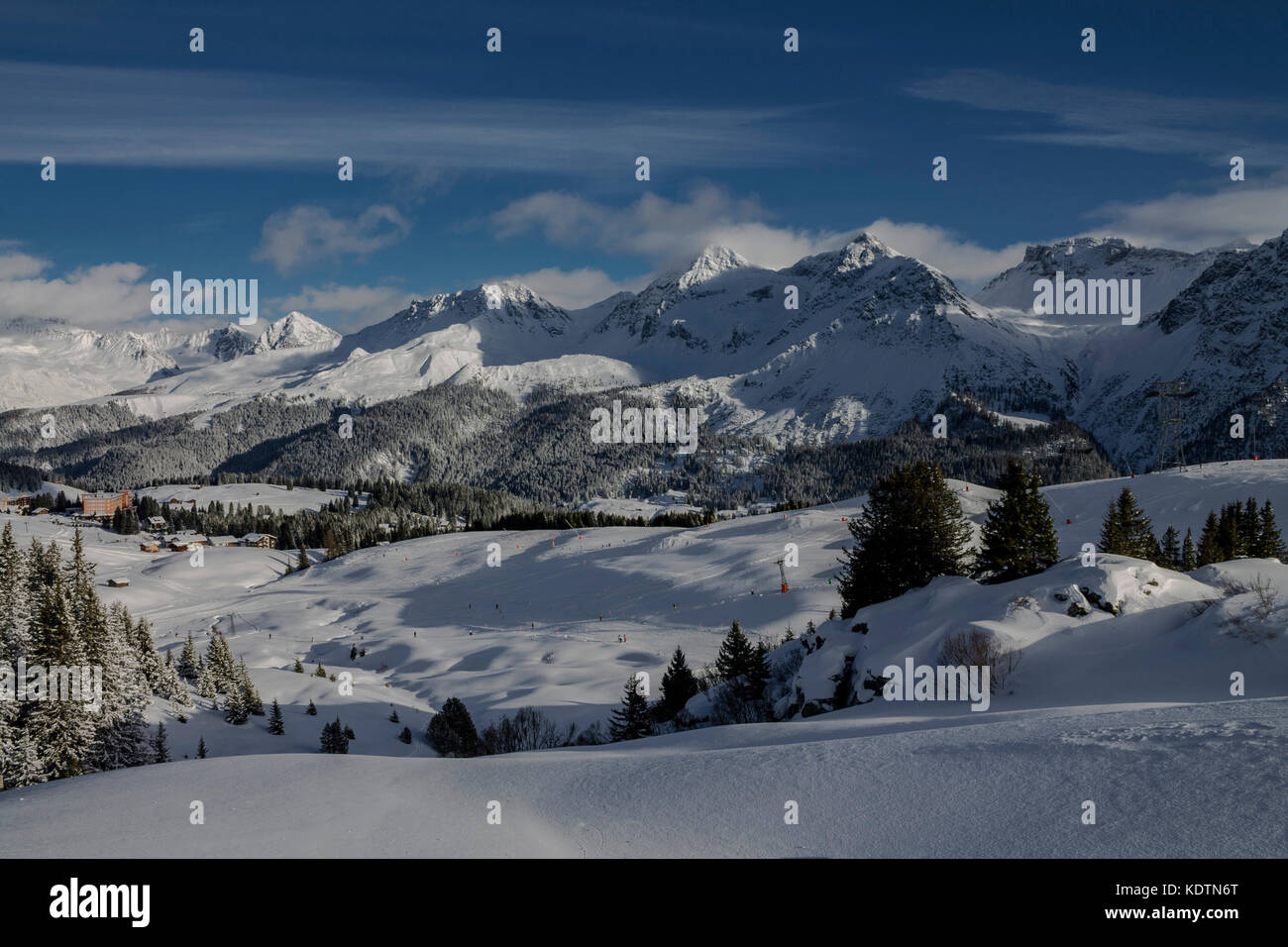 A Swiss snowscape with pine trees and mountains Stock Photo - Alamy
