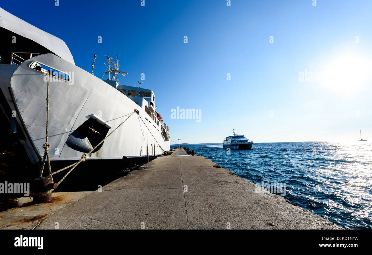 Front loading ferry boat moored with lifted bow at pier. Big ferry boat ...