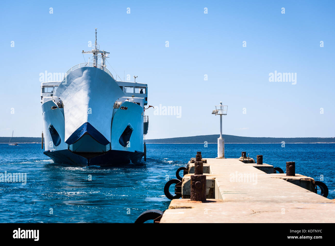 Front loading ferry boat moored with lifted bow at pier. Big ferry boat ...