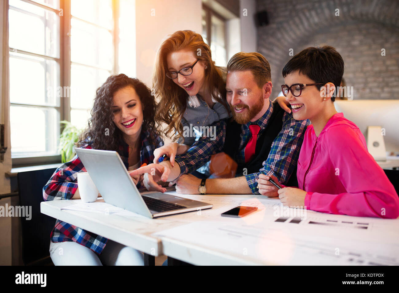 Group of young architects working on laptop Stock Photo - Alamy