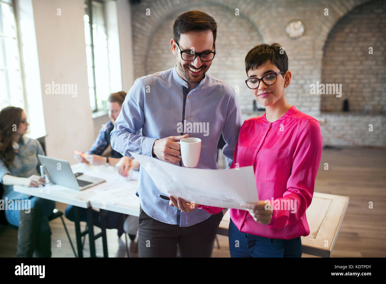 Portrait of two architects looking at project scheme Stock Photo - Alamy