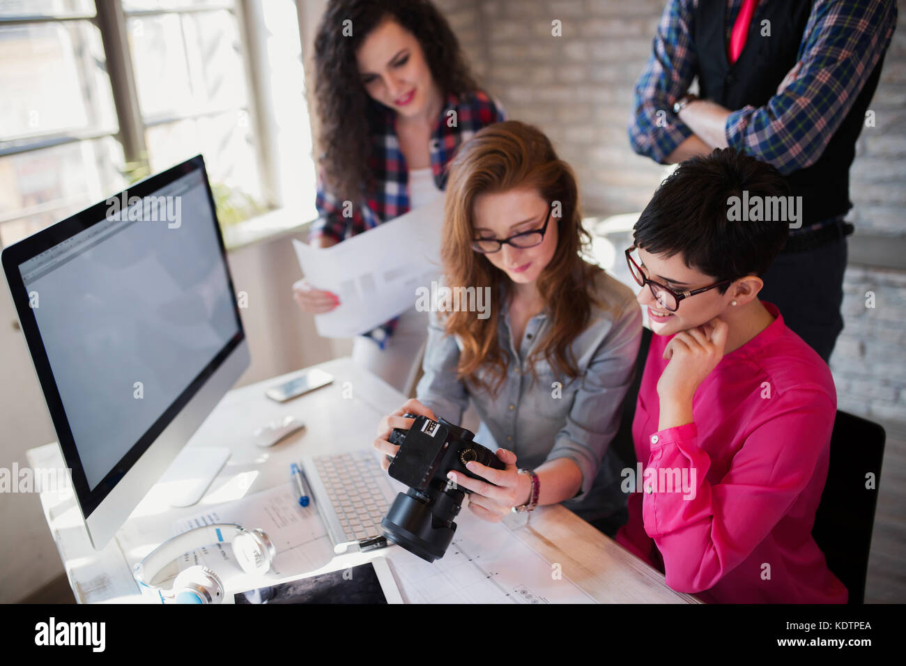 Group of young perspective designers working with camera Stock Photo ...