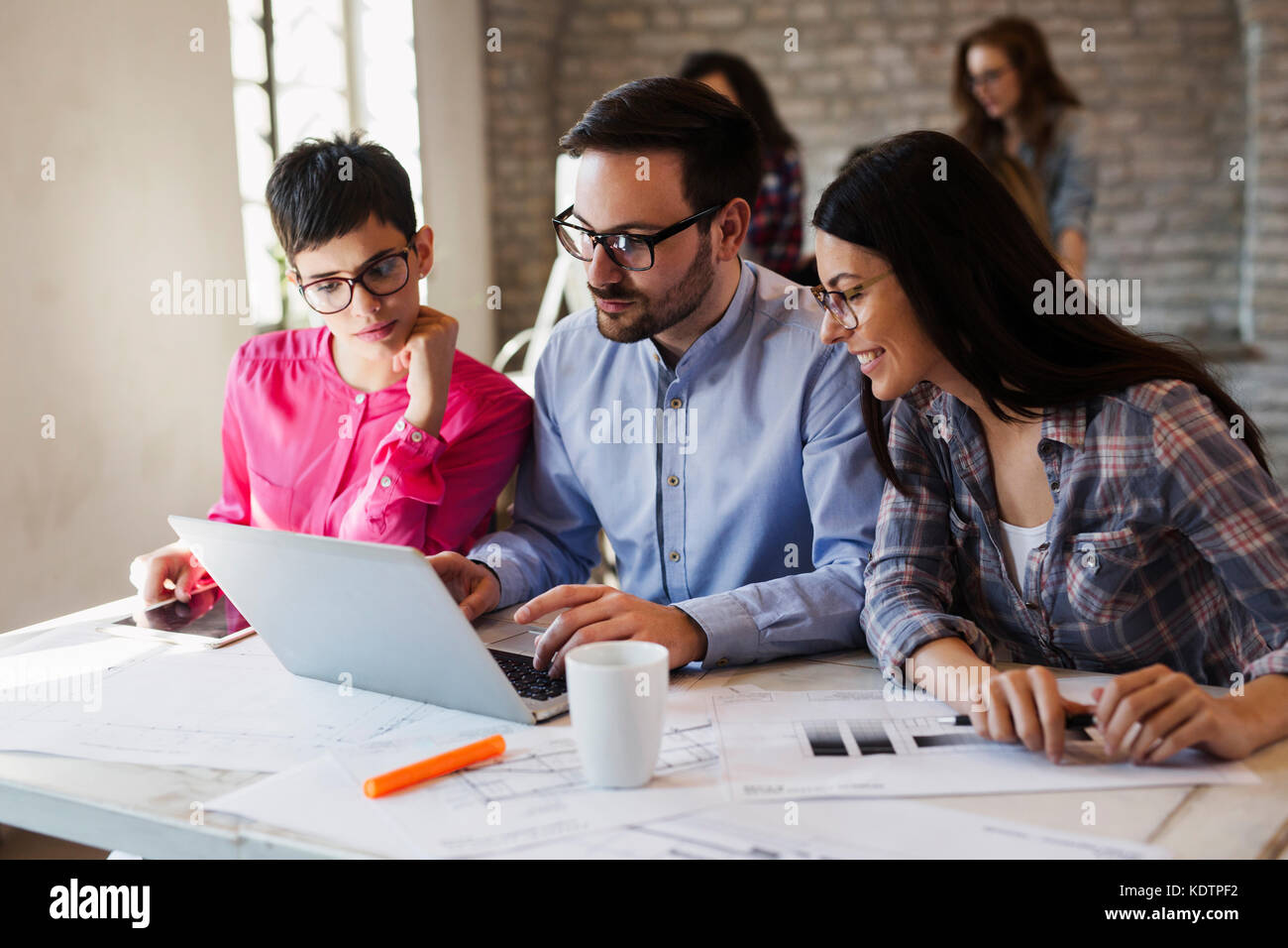 Group of young architects working on computer Stock Photo - Alamy