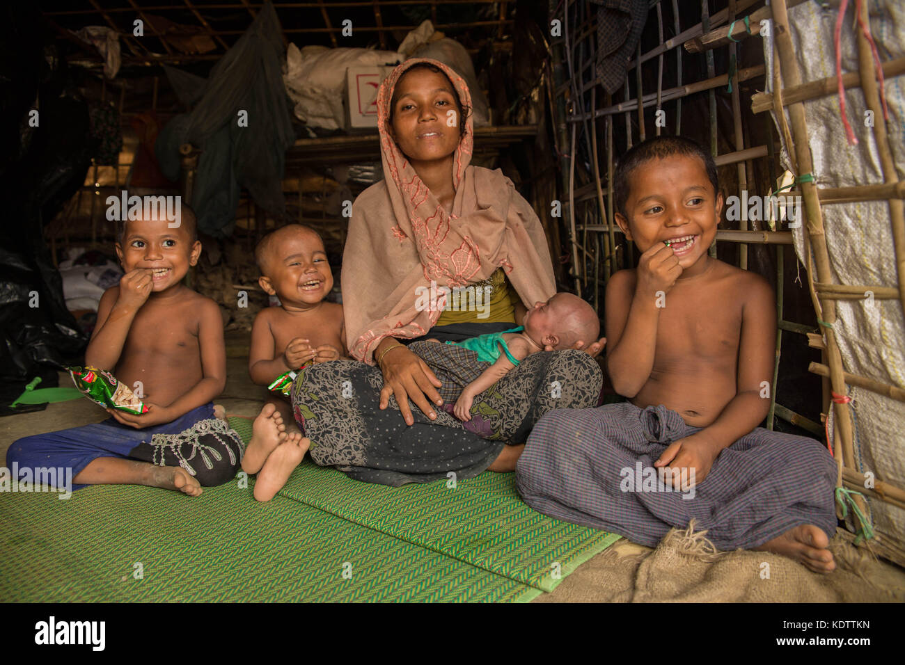 Rehena Begom, her three sons and her newborn daughter sit in a bamboo ...