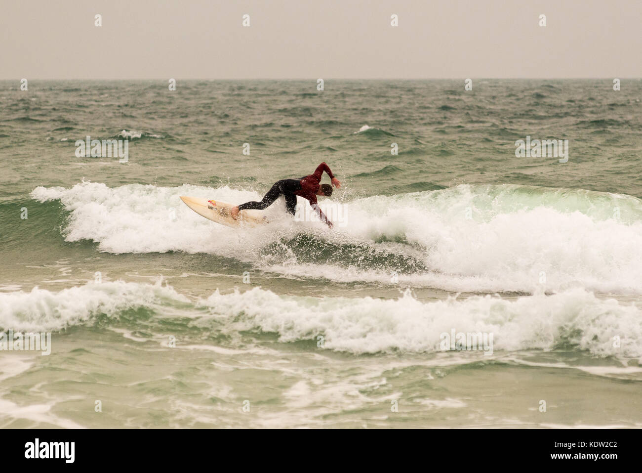Surfer taking a tumble in big waves and strong winds from storm, ex ...