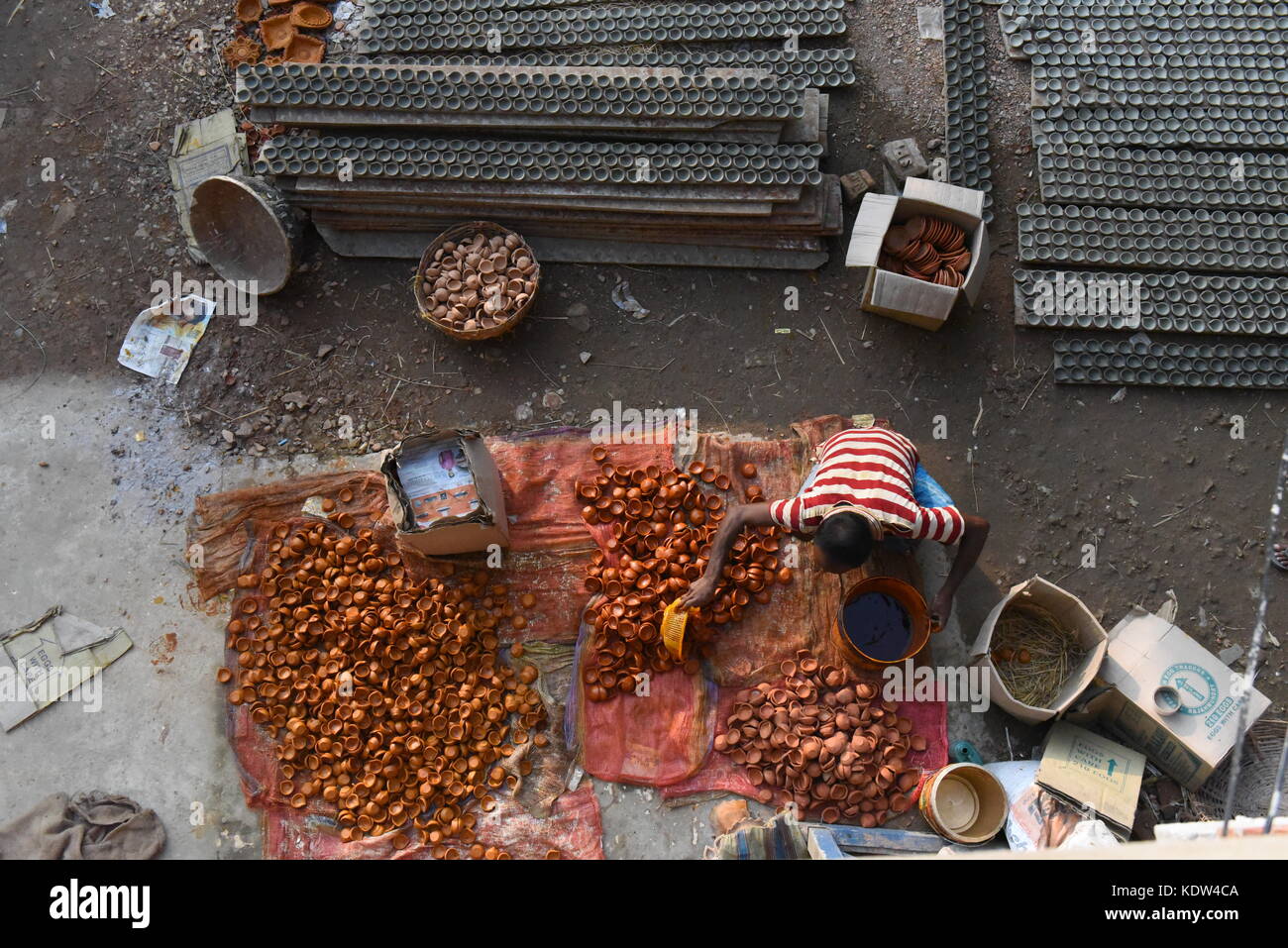 Potters are busy in giving final touch on the soil made diya which will ...