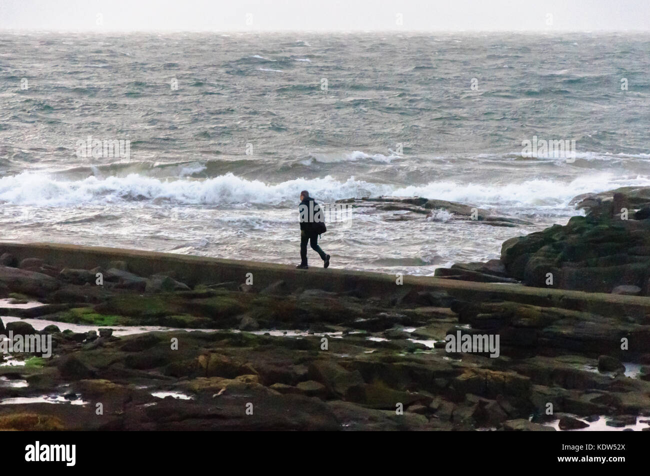 Troon, Scotland, UK. 16th October, 2017. UK Weather: A man takes a walk ...