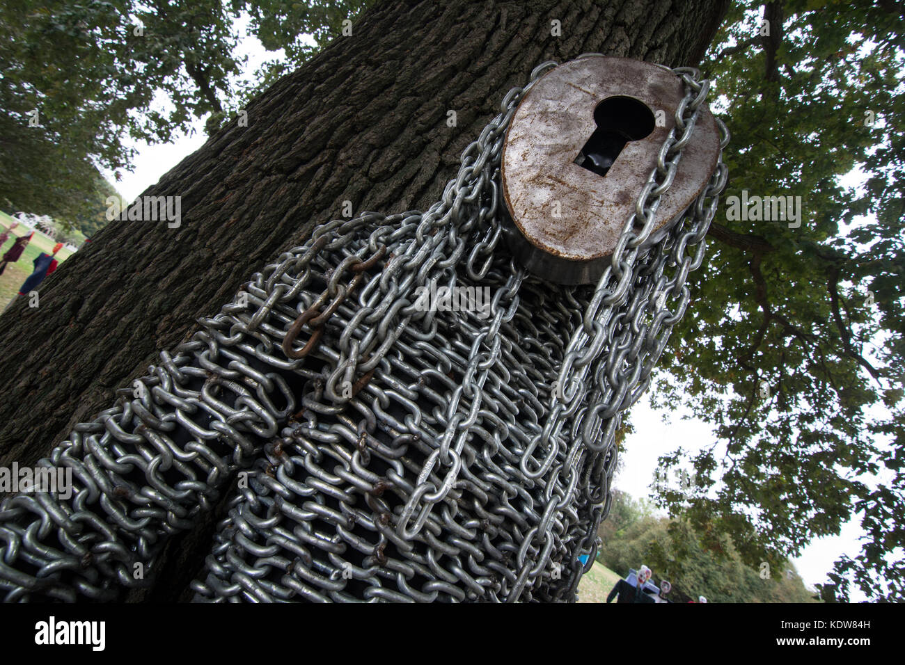 An artwork of a person crafted out of chain link, and a lock for a face ...