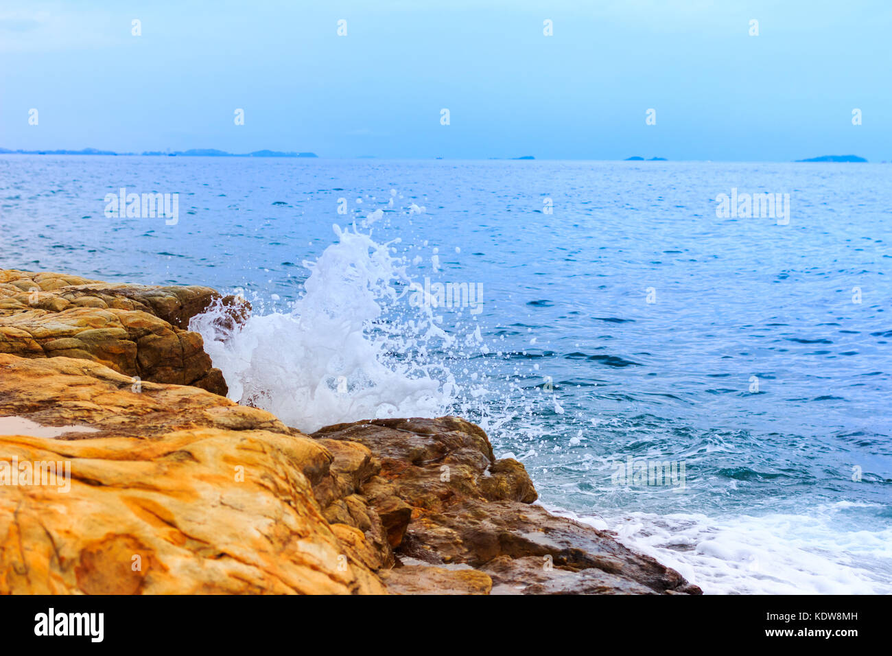 Water splashing. Crystal clear sea water beating against the rocks and ...