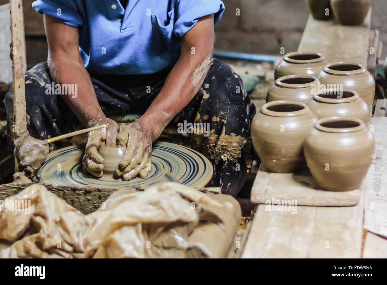 dirty hands making pottery in clay on wheel Stock Photo - Alamy