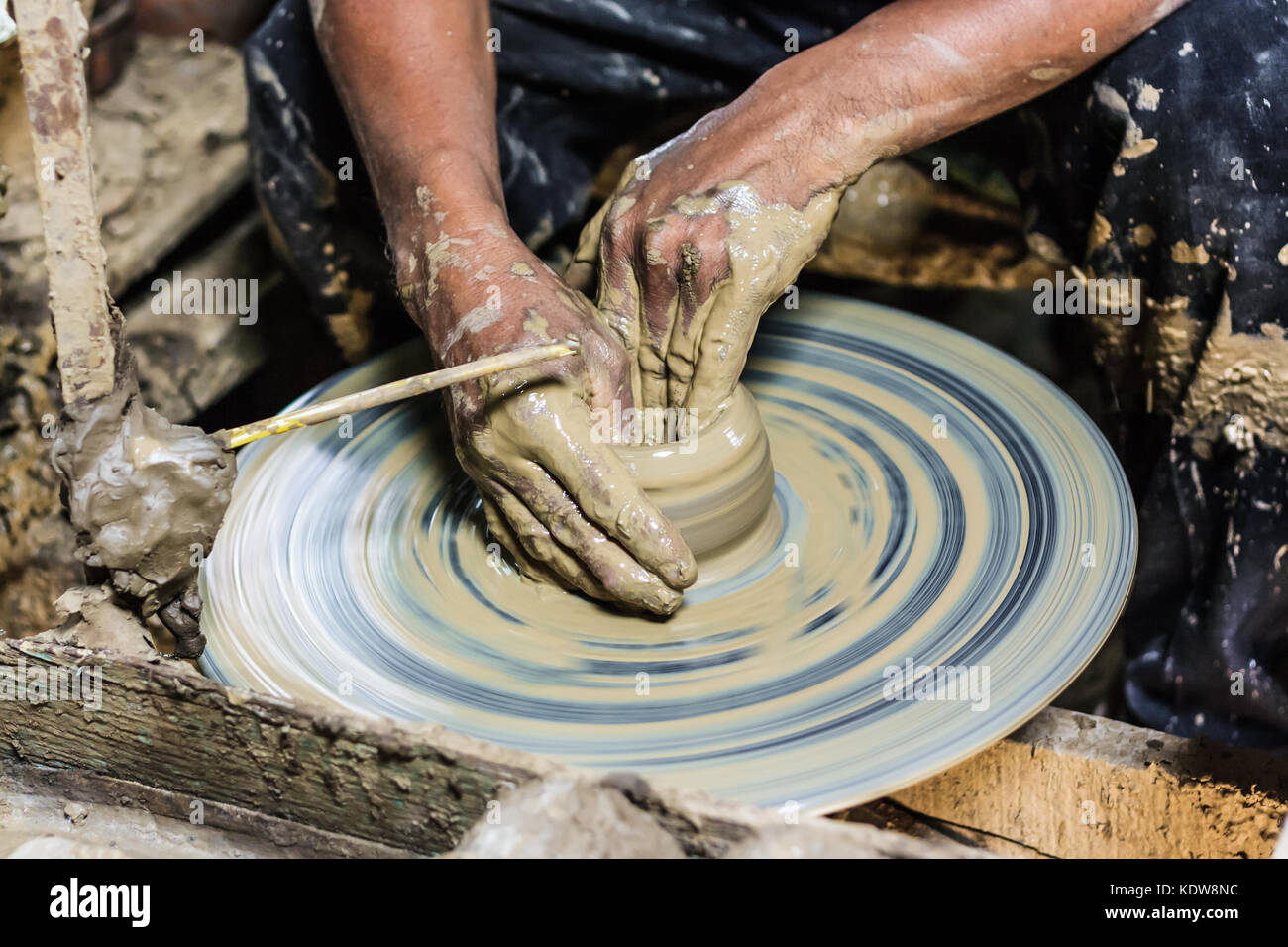 dirty hands making pottery in clay on wheel Stock Photo - Alamy
