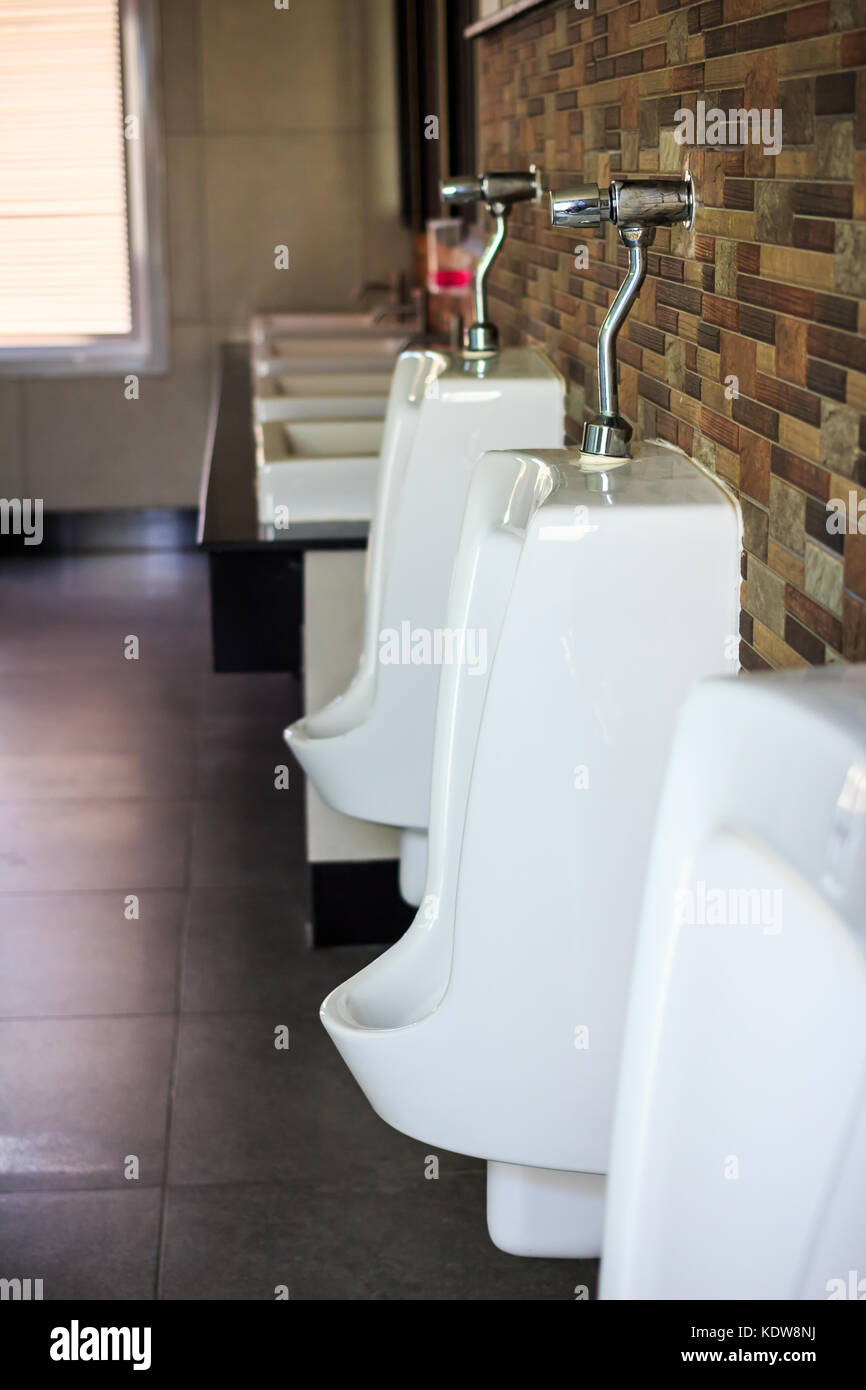 white porcelain urinals in public toilets Stock Photo - Alamy