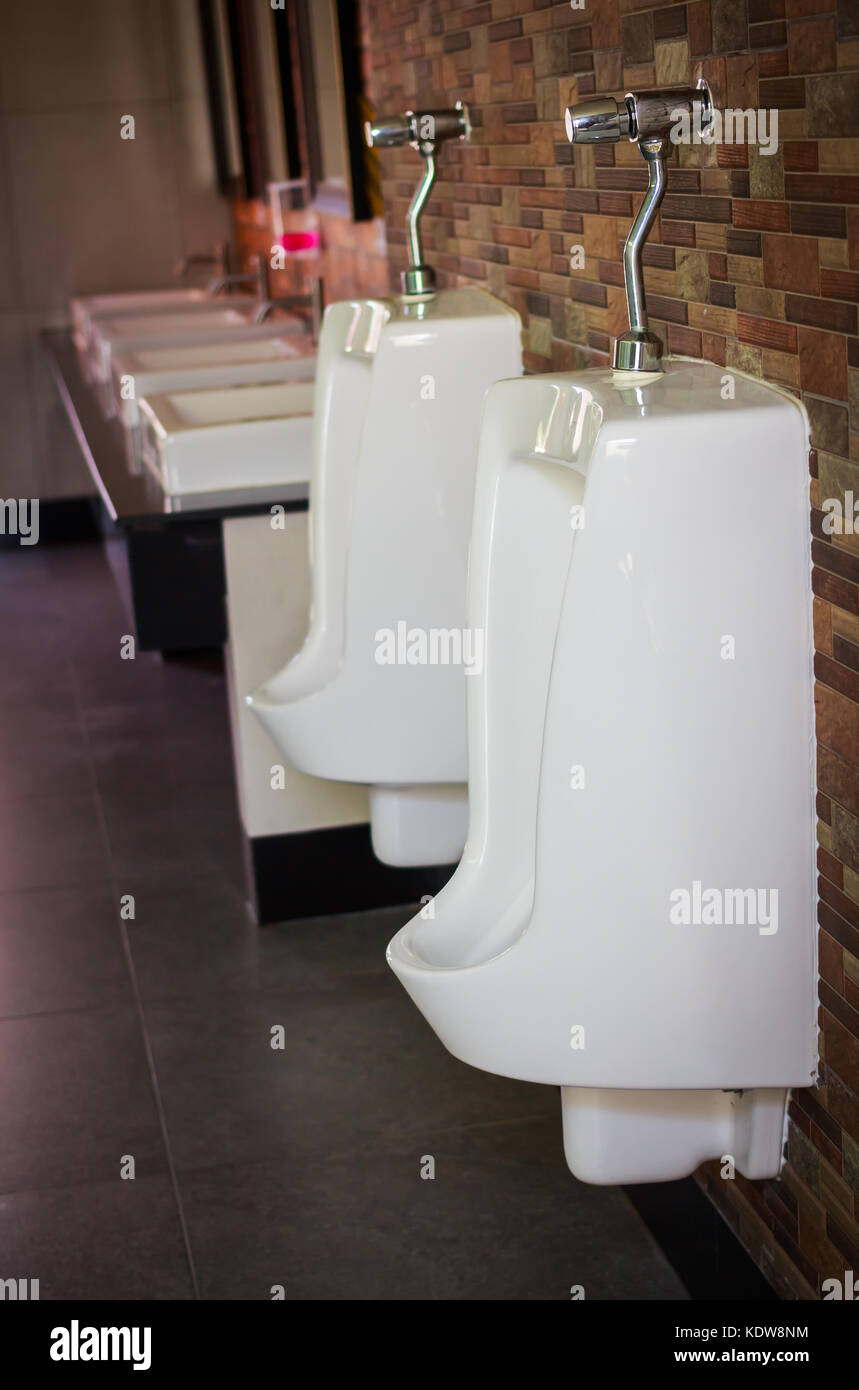 white porcelain urinals in public toilets Stock Photo - Alamy