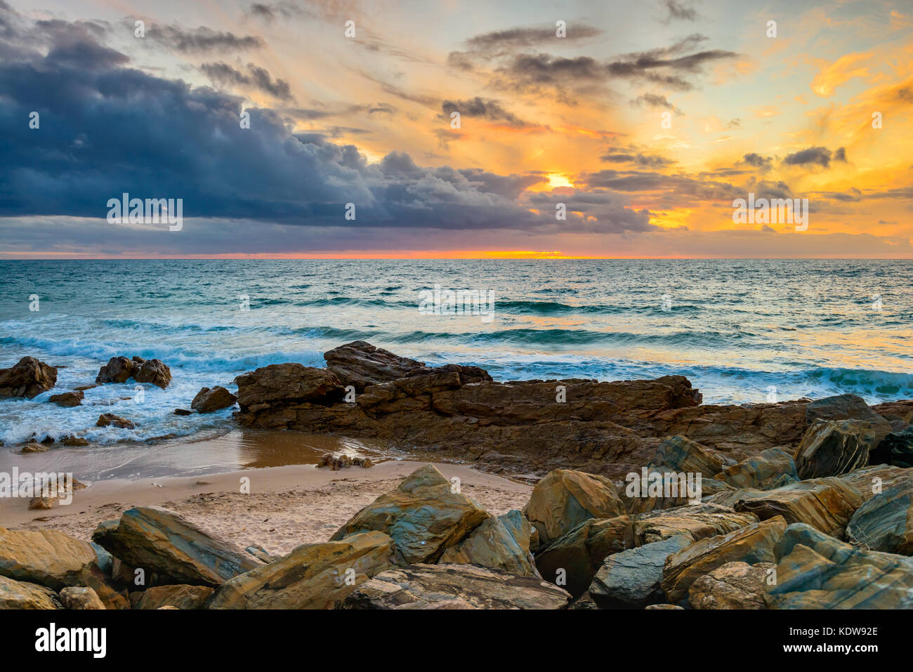 Dramatic sunset over rocky beach, South Australia Stock Photo - Alamy