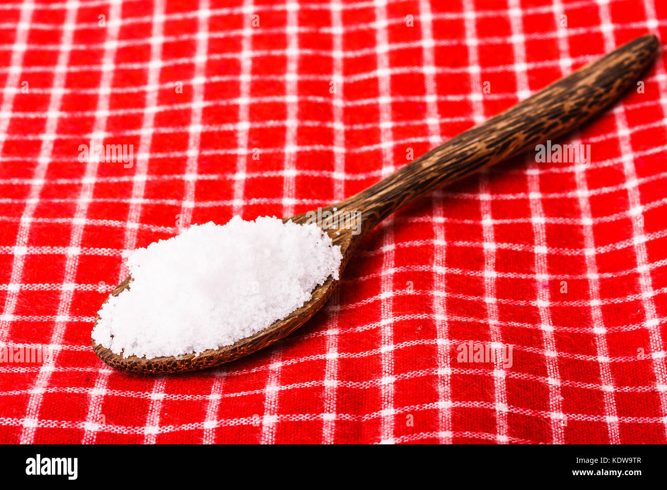 Salt on wood spoon Stock Photo - Alamy