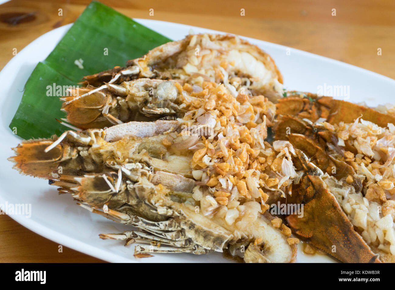 crayfish fried fill pickled garlic served on wood table Stock Photo - Alamy