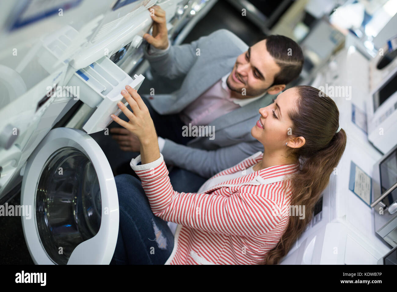 happy salesman and customer in store of domestic appliances Stock Photo ...