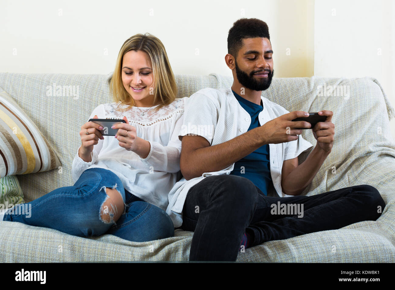 Portrait of couple addicted to smartphones and games online Stock Photo ...