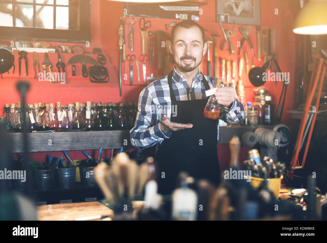 Male worker choosing colorant for leather in leather workshop Stock ...
