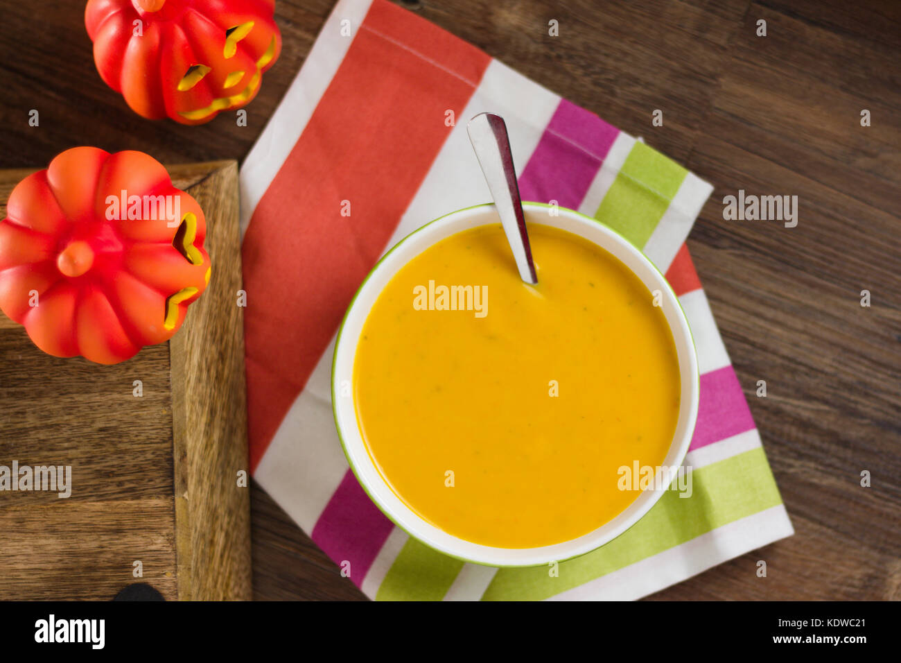 Top down view on simple plain creamy pumpkin soup in green bowl ...