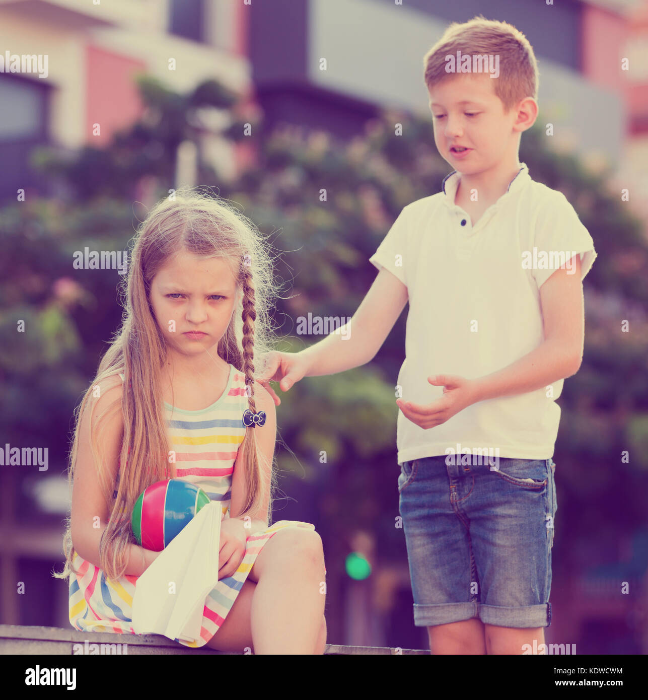 portrait of angry girl in elementary school age not playing with friend ...