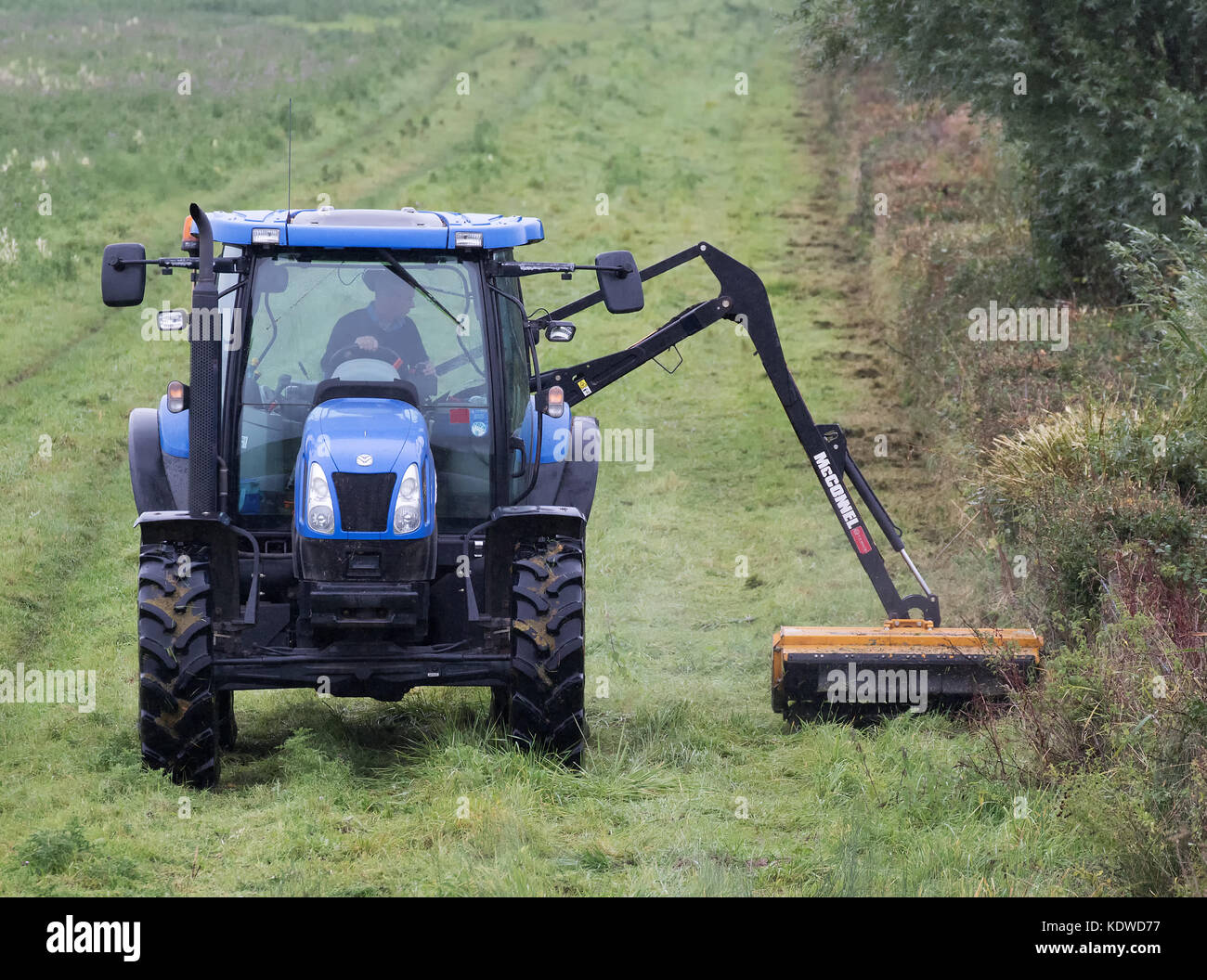 Tractor mowing field edge at Slimbridge Stock Photo - Alamy