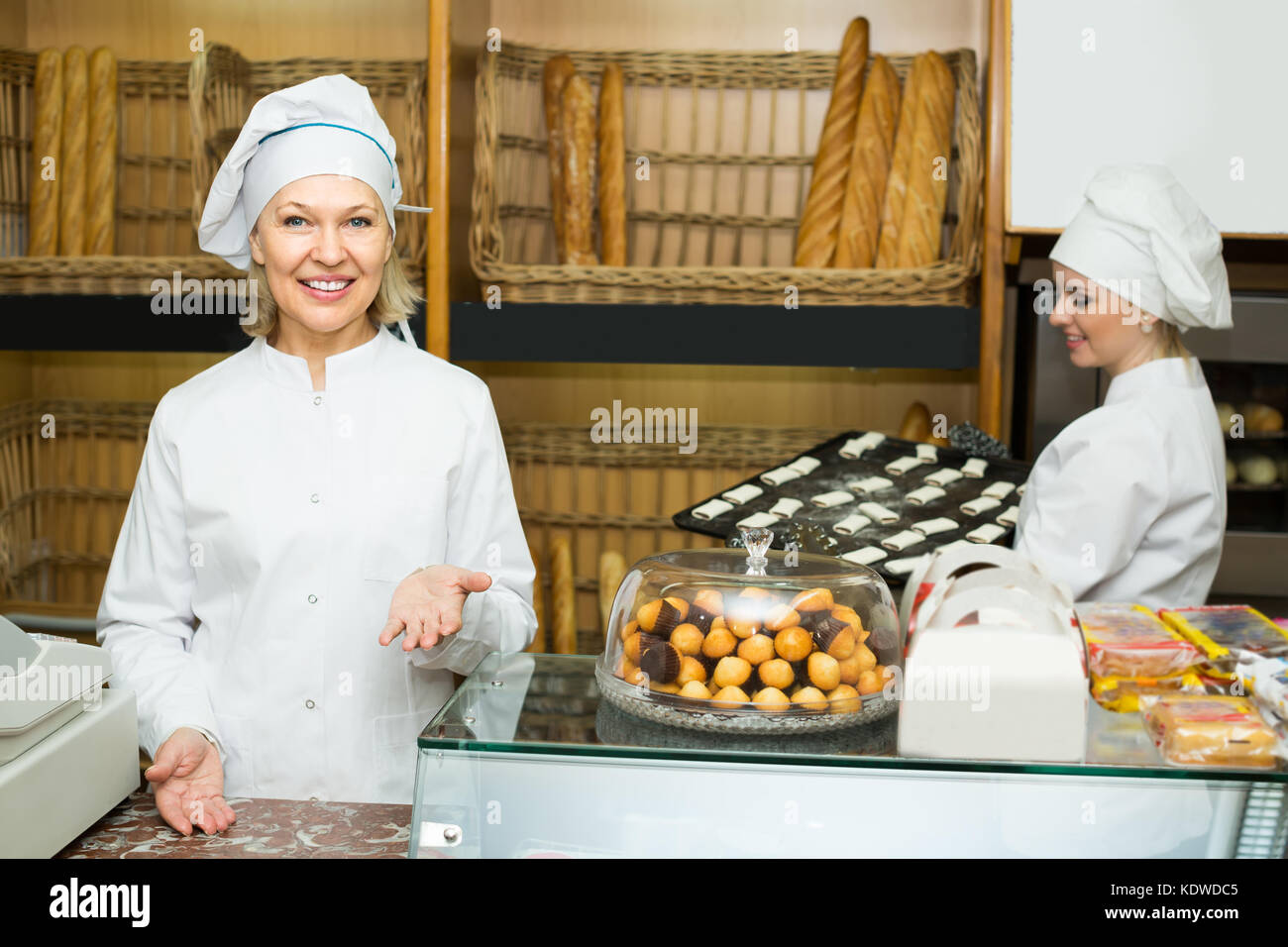 Portrait of two joyful smiling female bakers in bakery Stock Photo - Alamy