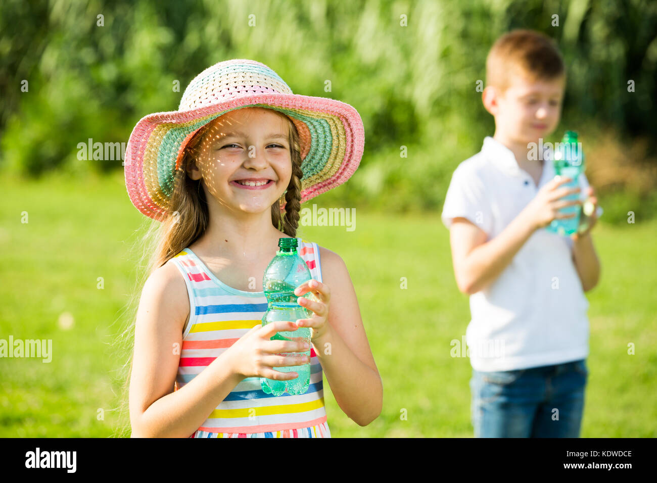 Child drinking water sun hat hi-res stock photography and images - Alamy