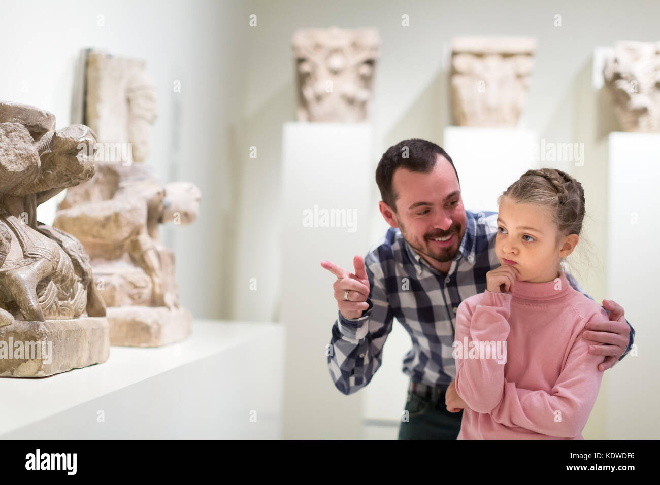 Smiling man and small daughter looking ancient statues in museum Stock ...