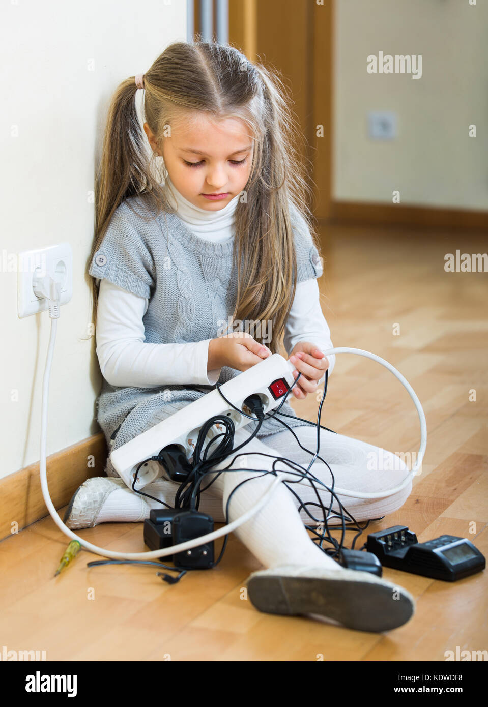 Little girl dangerously playing with sockets and electricity alone at ...