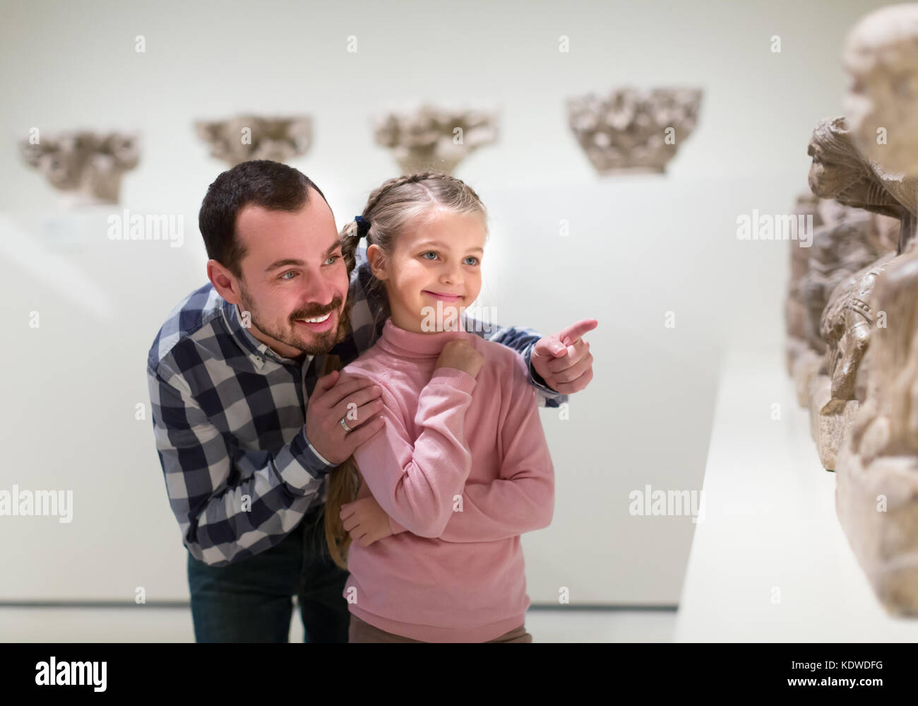 Happy man and small daughter looking ancient statues in museum Stock ...