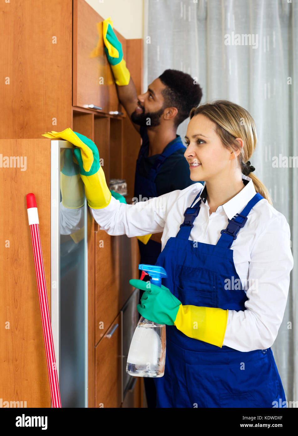 Attractive cleaners cleaning and dusting in ordinary house Stock Photo ...