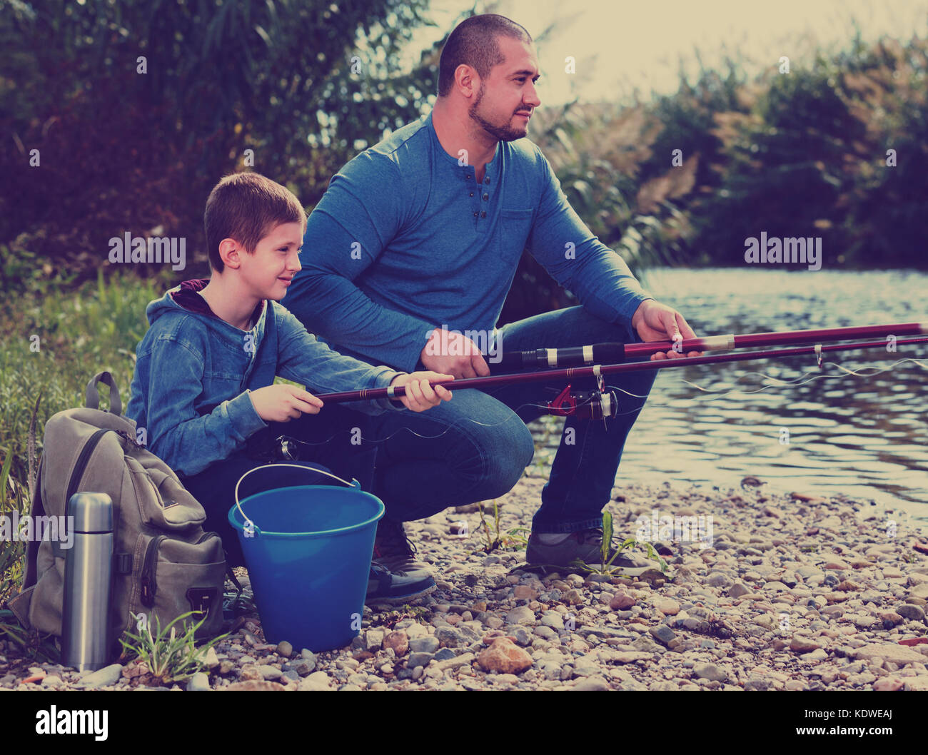 Portrait of father and son fishing with rods in summer day Stock Photo ...