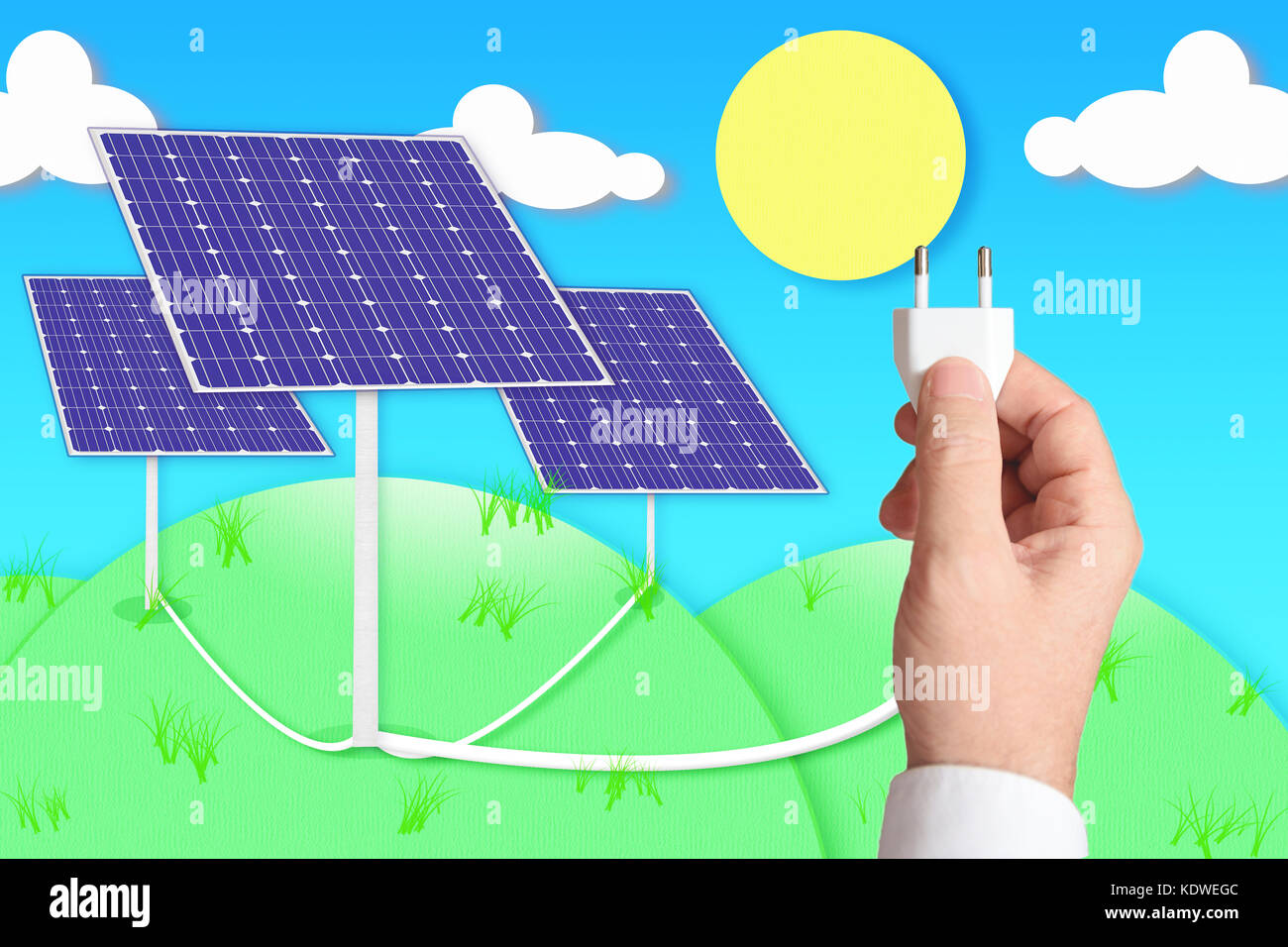A hand holding a plug connected to some solar photovoltaic panels ...
