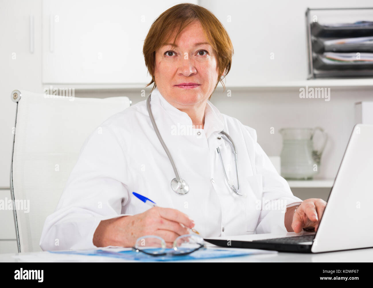 Female doctor having a productive day helping in her office Stock Photo ...
