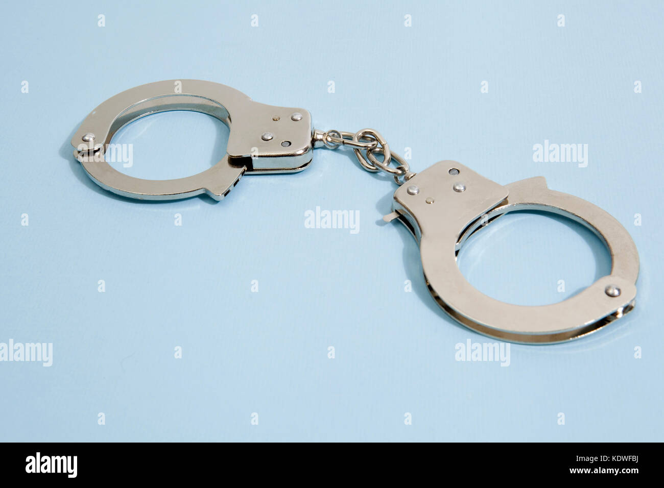isolated handcuffs on a pop vibrant color background. Minimal color ...