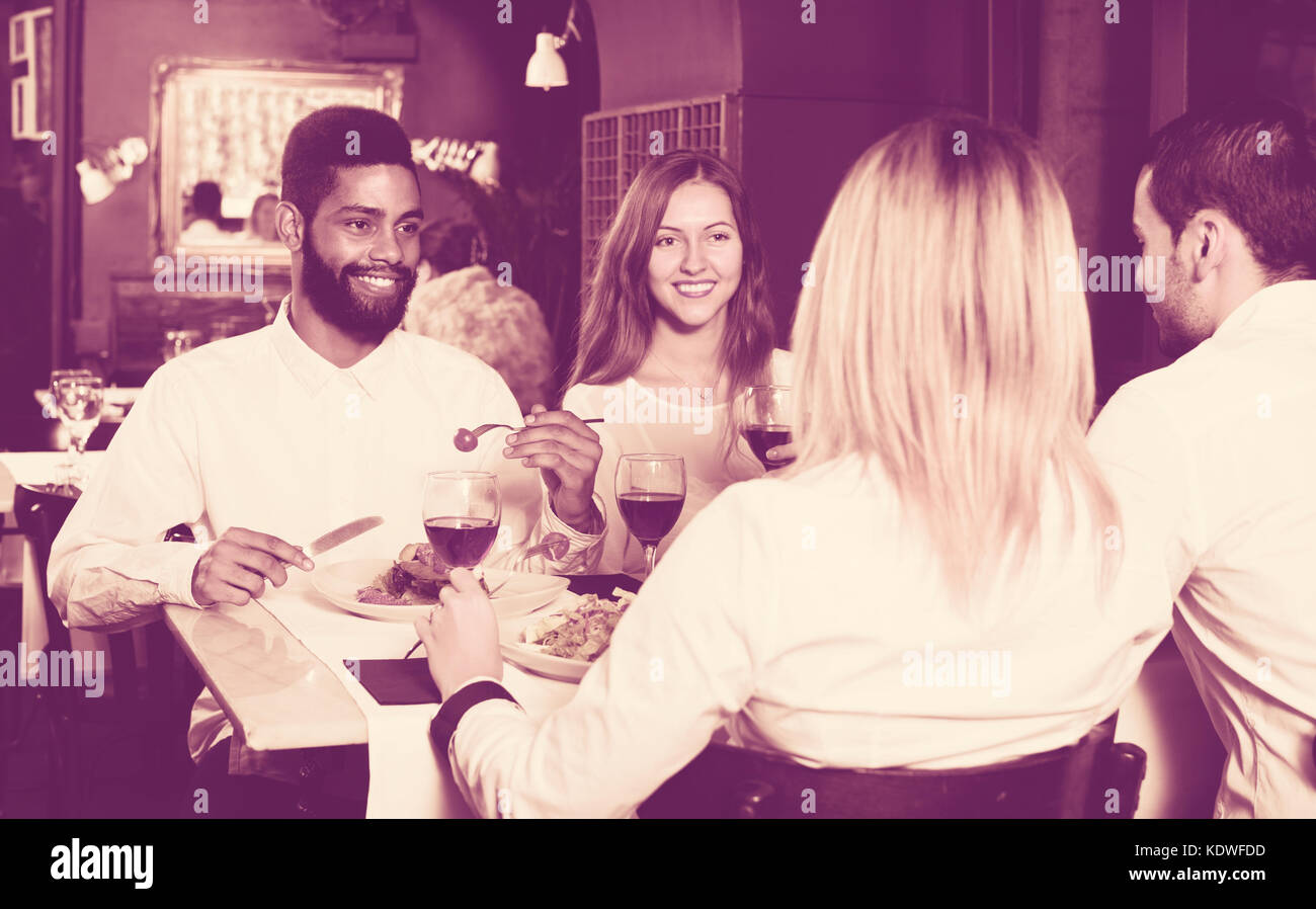 Happy middle class people enjoying food in cafe and talking Stock Photo ...