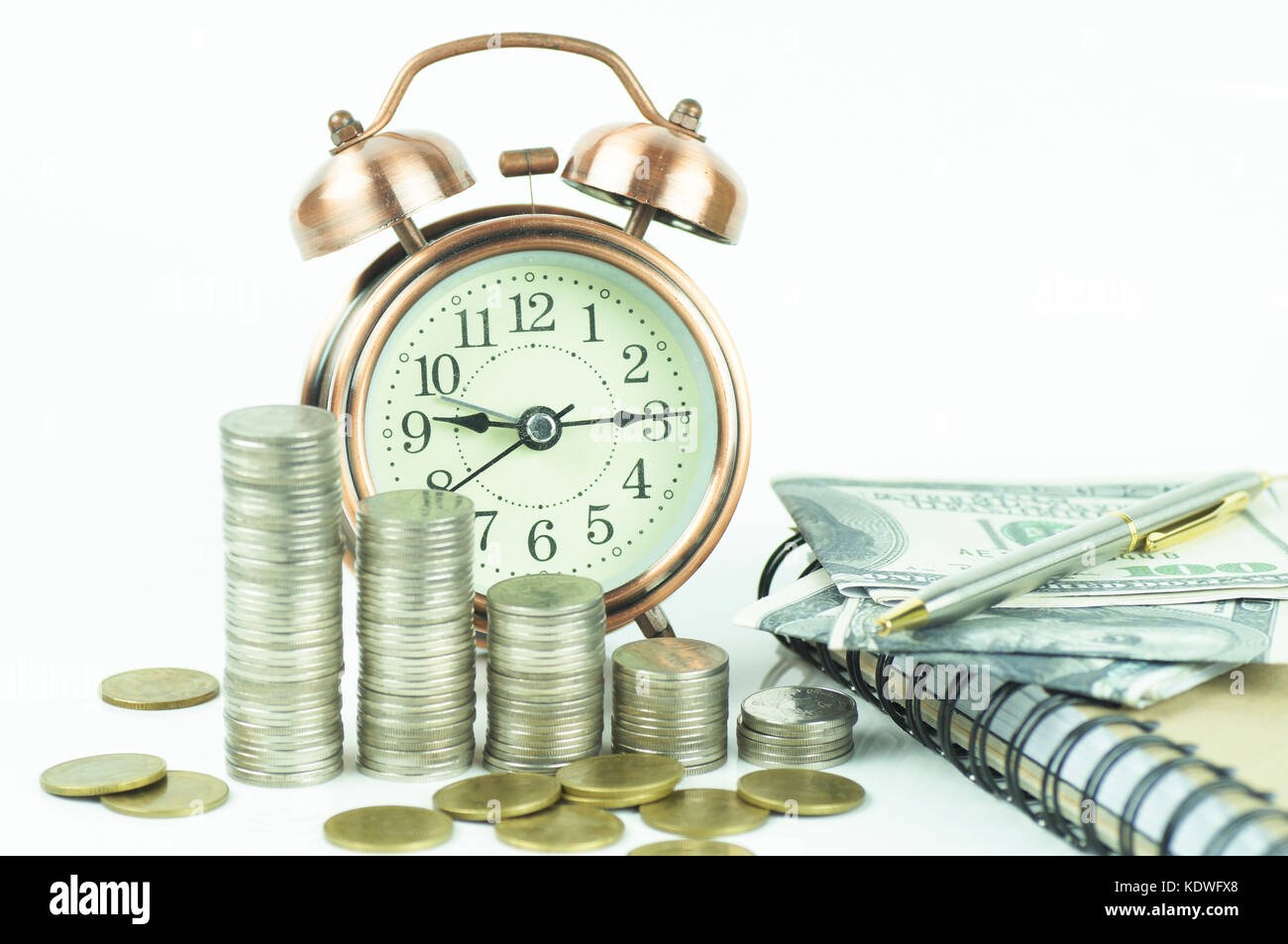 stacked of coins, alarm clock on white background with business ...