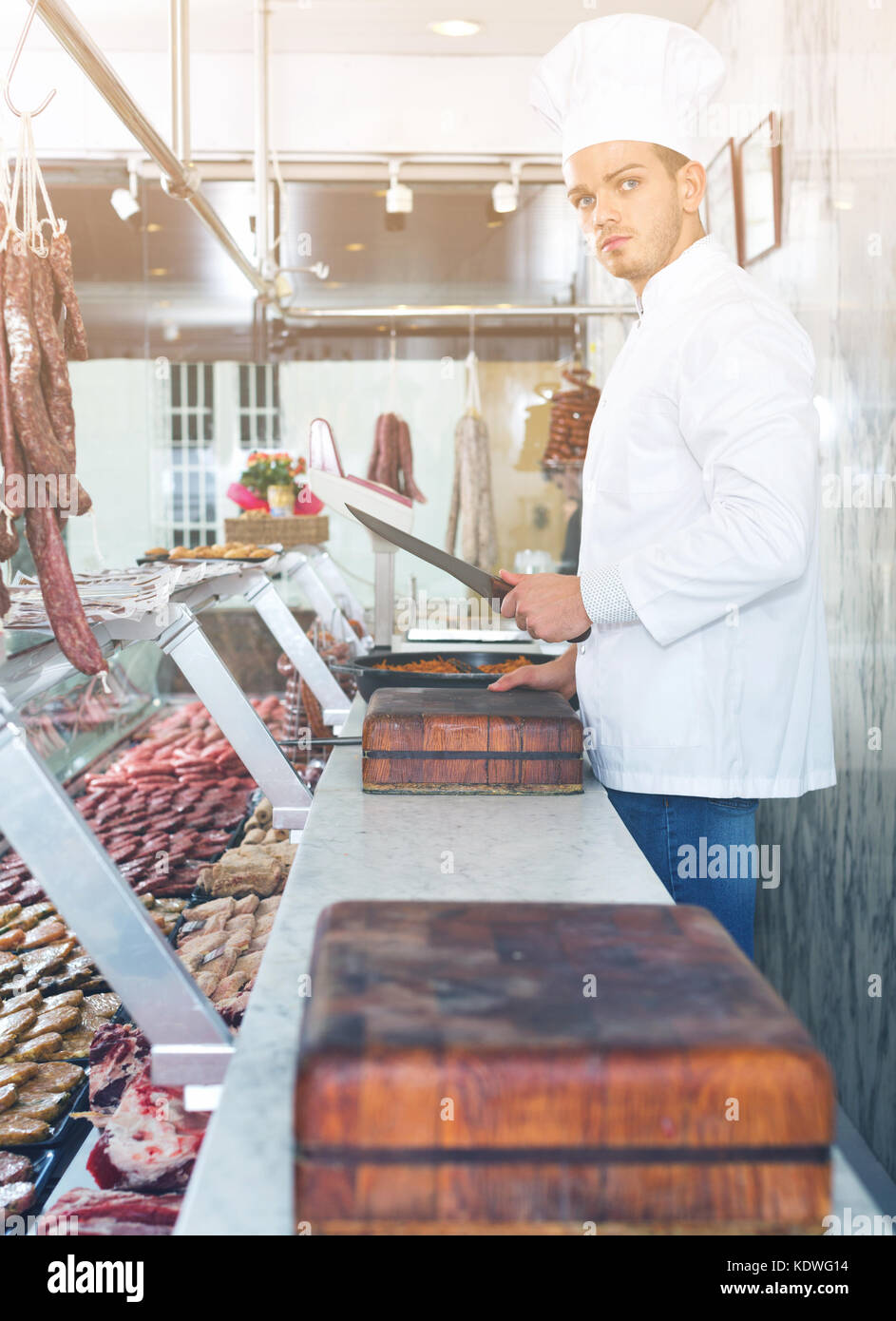 Diligent professional cook sniffing freshly cooked dish at store Stock ...