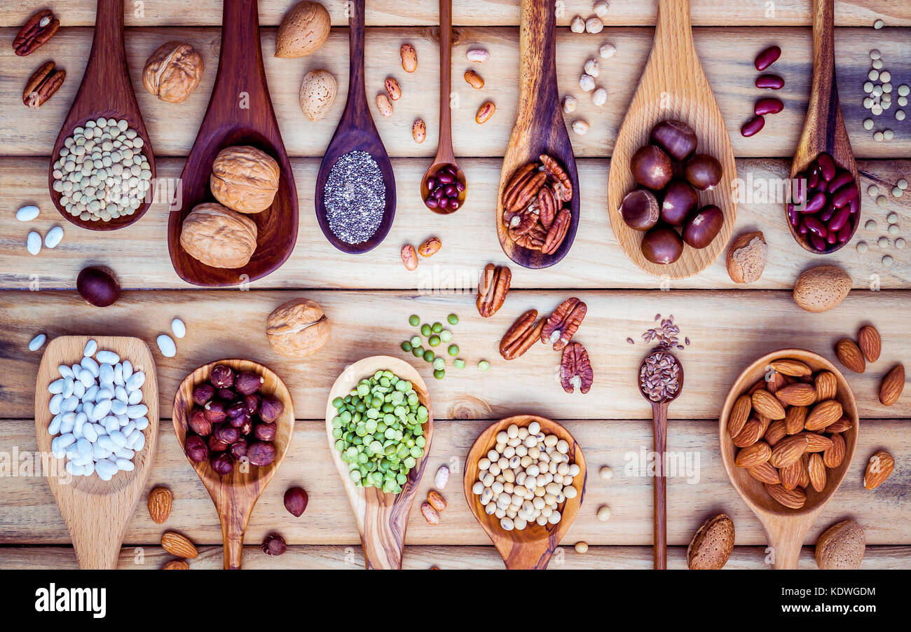 Various legumes and different kinds of nutshells in spoons. Walnuts ...