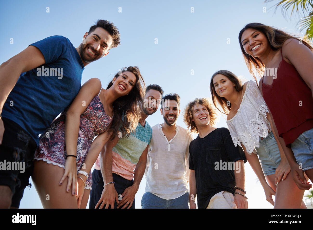 Bottom view of group of friends standing together outside smiling Stock ...