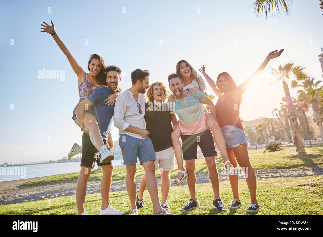 Portrait of group of friends having fun together outside in sunlight ...