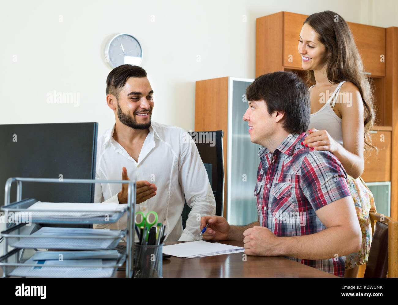 Couple and spanish manager talking cheerfully about purchase in the ...