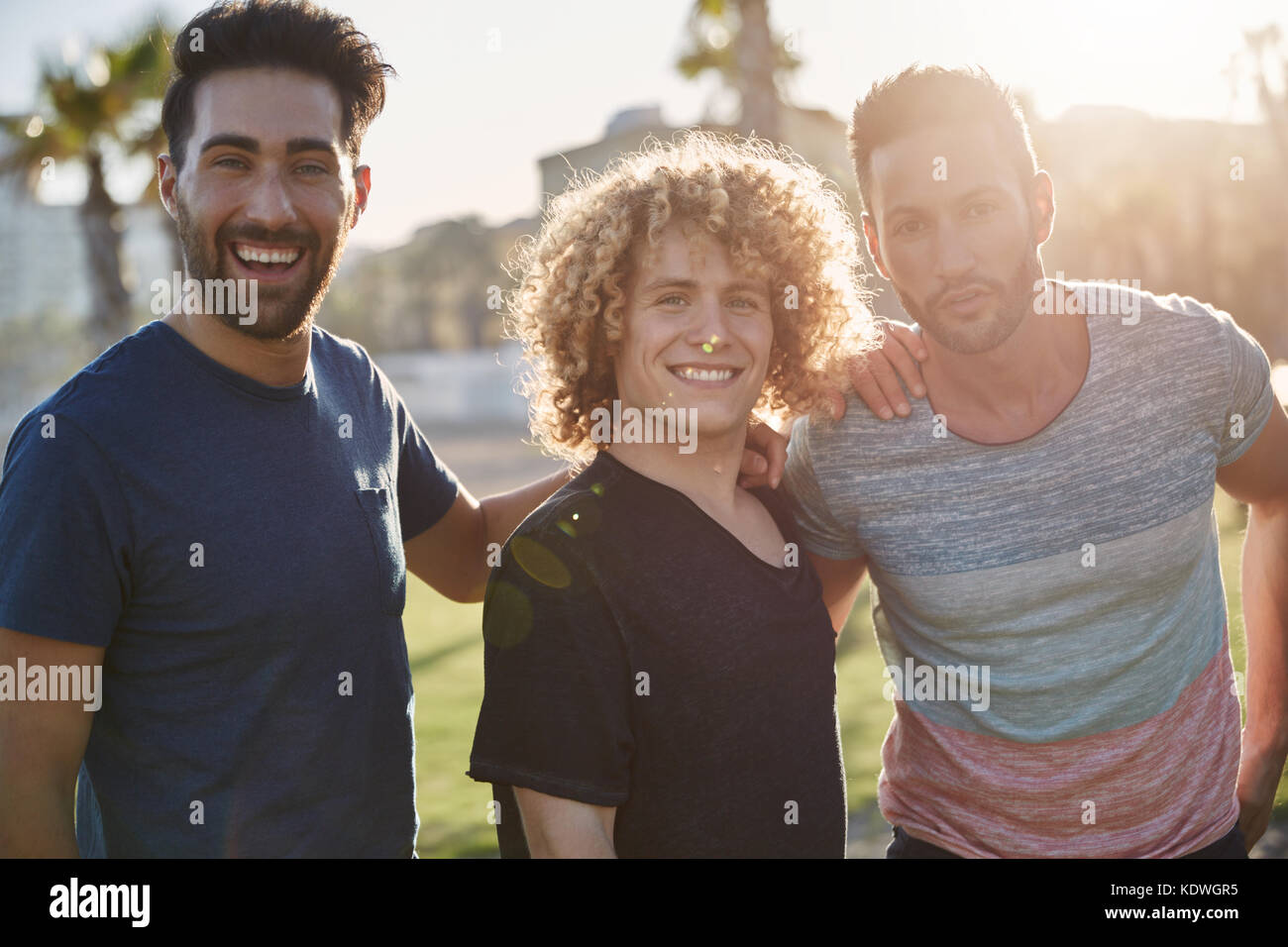 Three friends standing in embrace hi-res stock photography and images ...