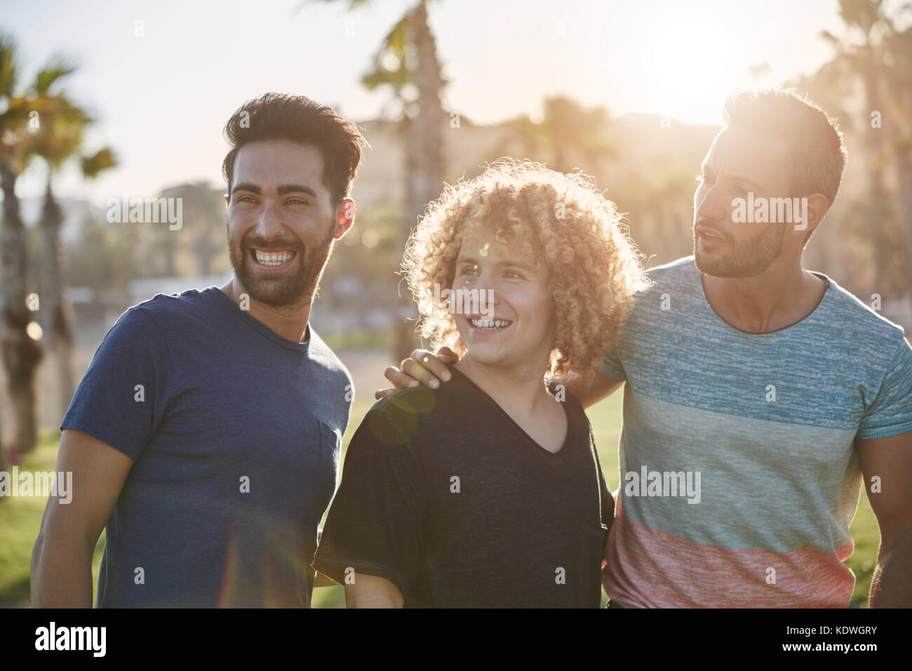 Three male friends standing together hi-res stock photography and ...